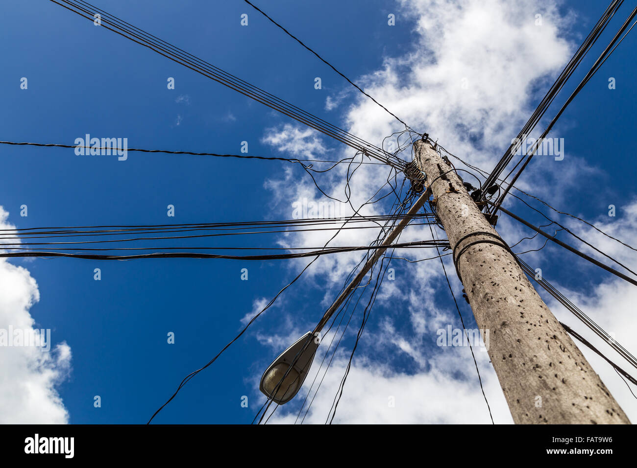 Telephone & electric wires spread out all directions from the top of a ...