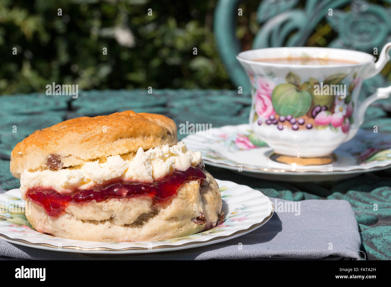A fresh scone filled with whipped Cornish clotted cream and strawberry ...