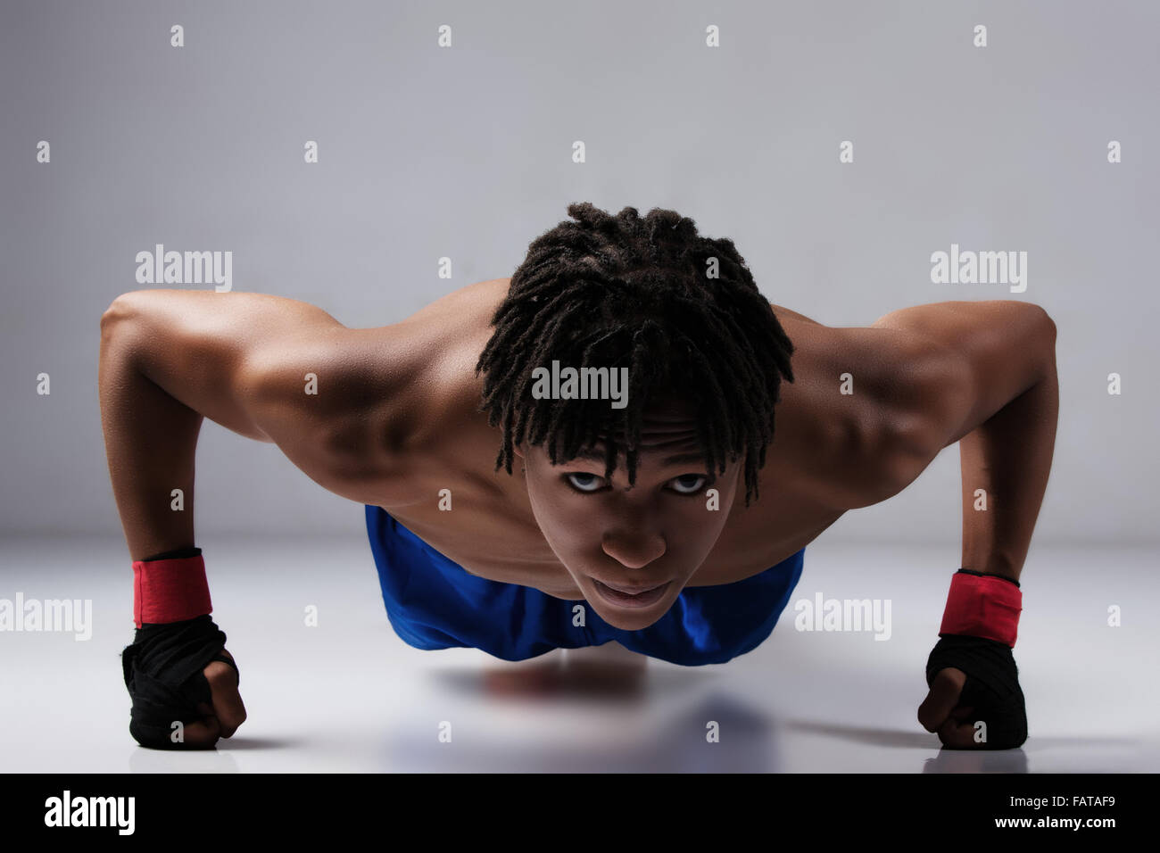 Young muscular athletic male boxer wearing blue boxing shorts and red ...