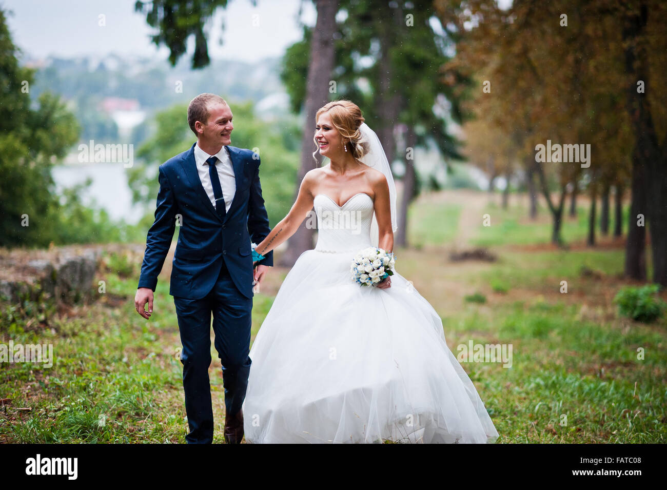 Married walking in the rain at park Stock Photo - Alamy