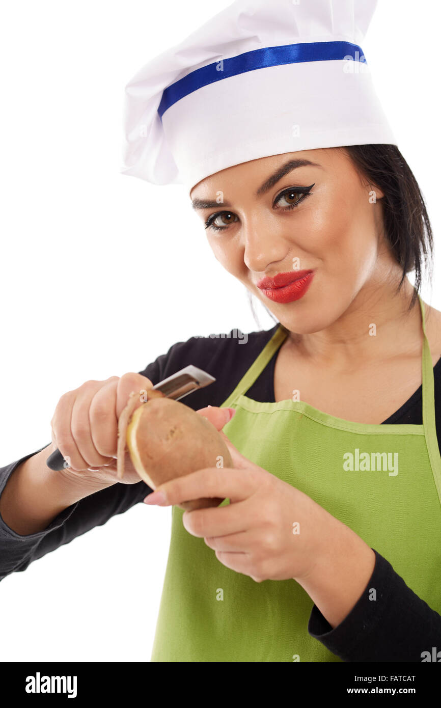 Beautiful woman cook peeling a potato, isolated on white background ...
