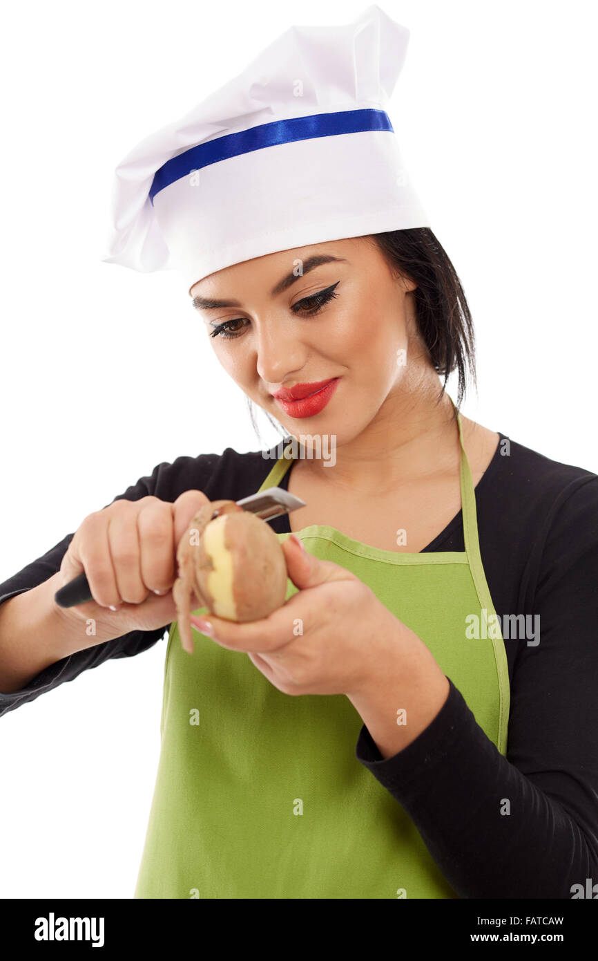 Beautiful woman cook peeling a potato, isolated on white background ...