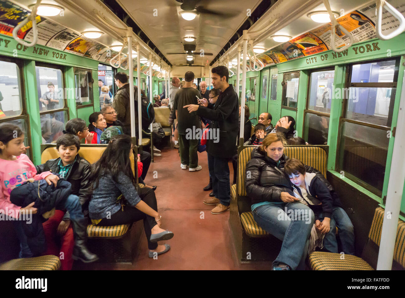 New Yorkers, tourists and subway buffs travel on a vintage MTA ...