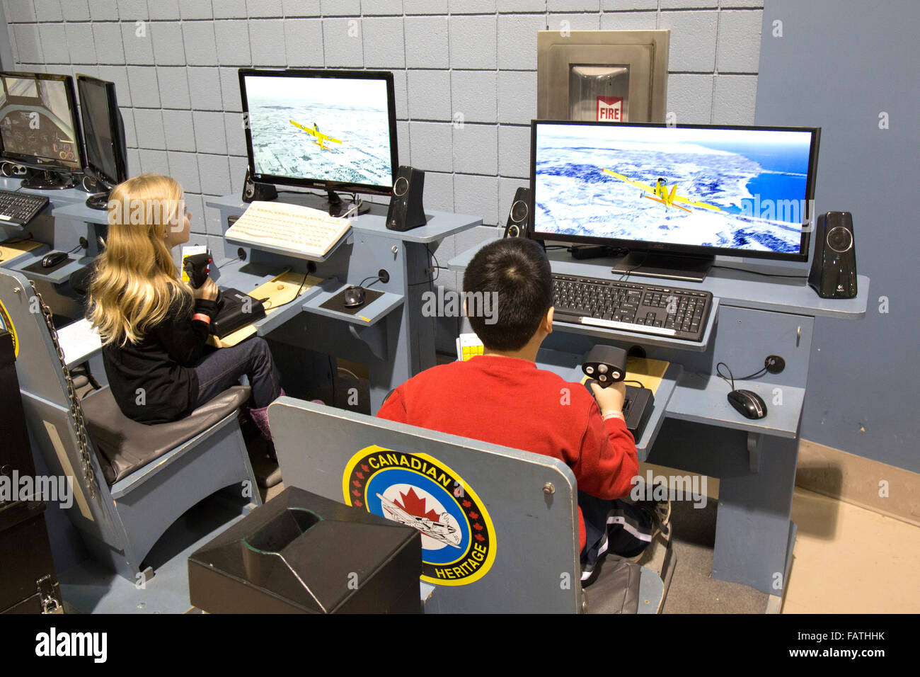Two young children playing on Flight Simulators inside the Canadian ...