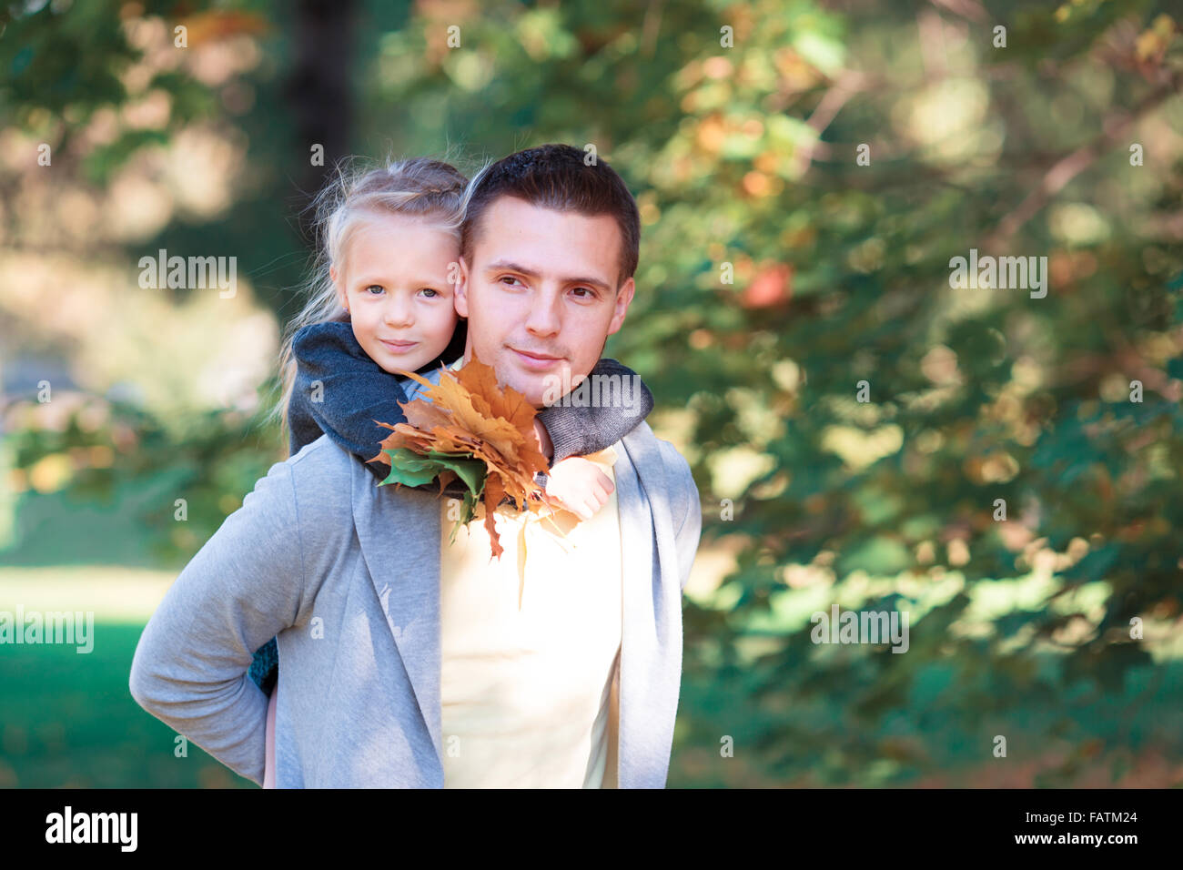 Father and kid in autumn park at warm day Stock Photo - Alamy