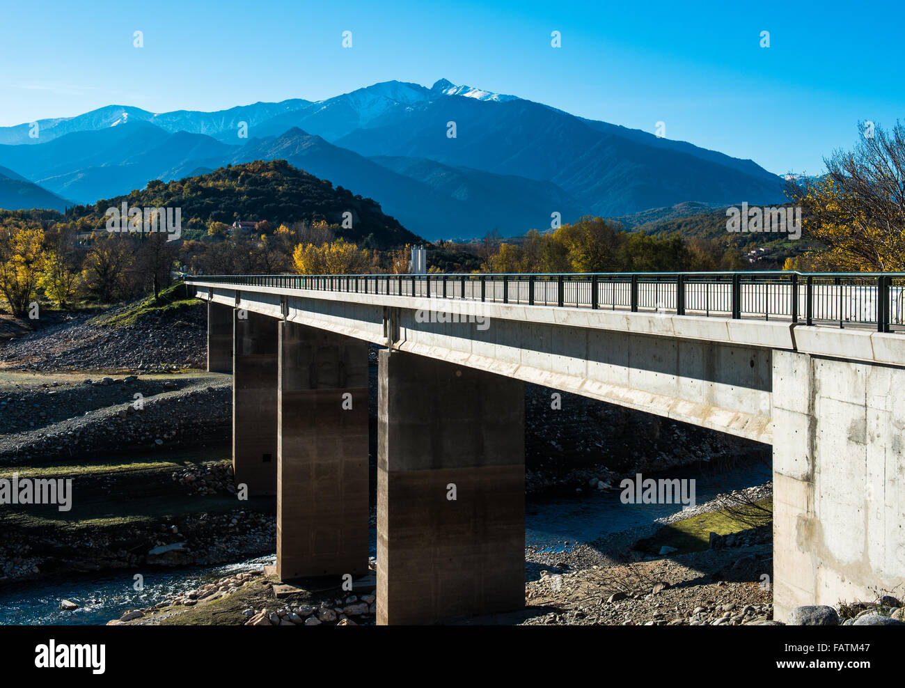 Bridge across the river in the French Pyrenees and picturesque mountain ...