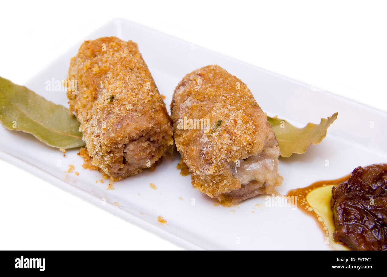 Breaded meat rolls on the tray on white background seen up close Stock ...