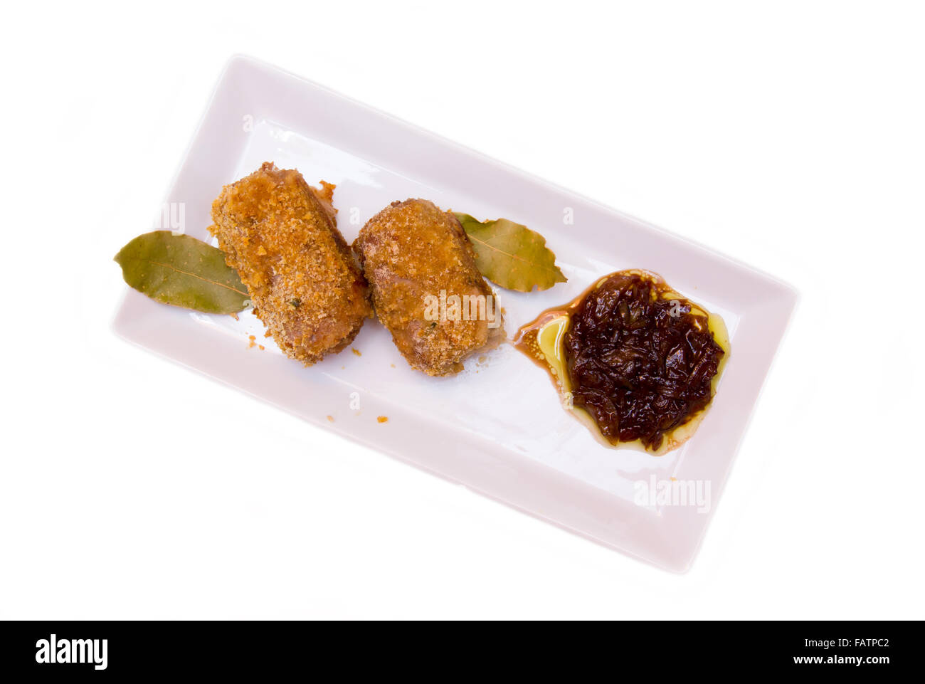 Breaded meat rolls on the tray on white background seen from above ...