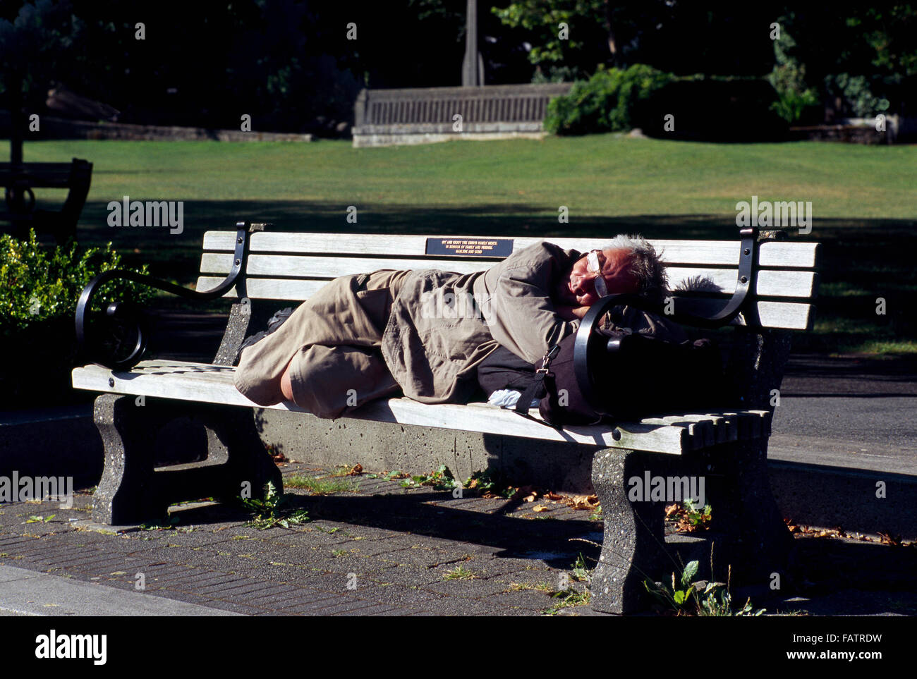 Homeless Man sleeping on Park Bench, Downtown Vancouver, BC, British ...