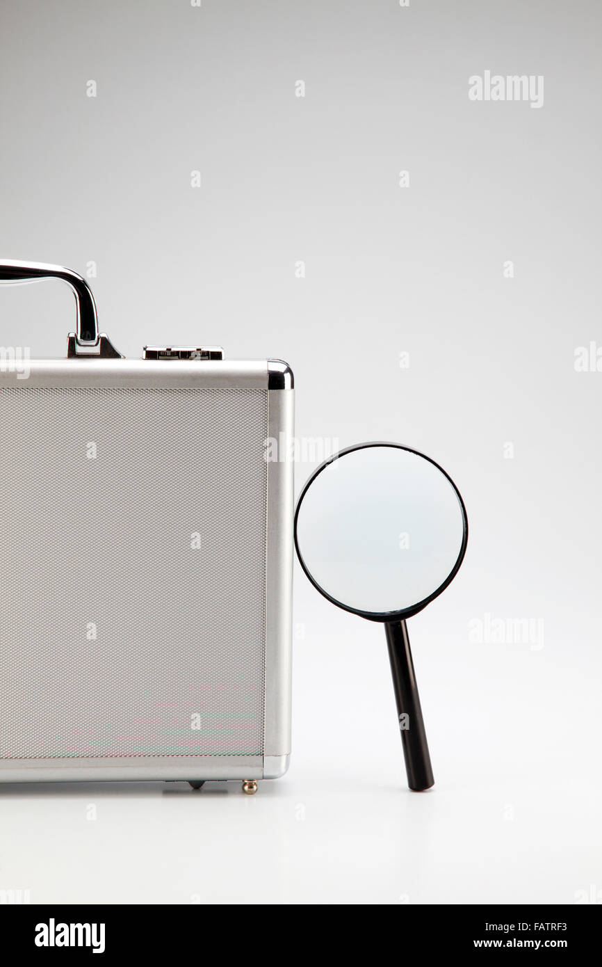 aluminium brief case with the magnifier glass Stock Photo - Alamy