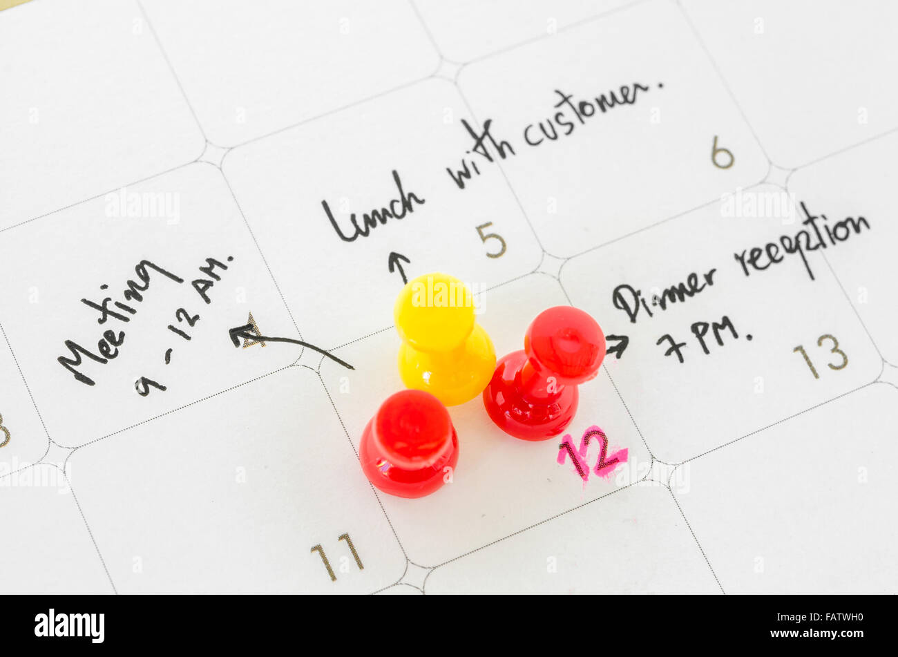 Pushpin on calendar with busy day overworked schedule Stock Photo - Alamy