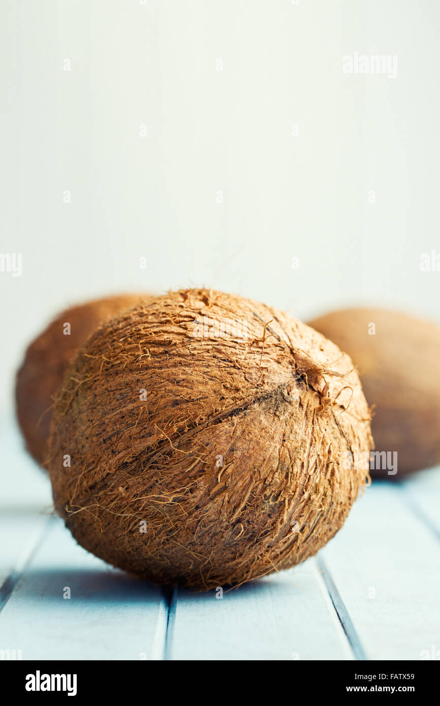 whole coconuts on kitchen table Stock Photo - Alamy