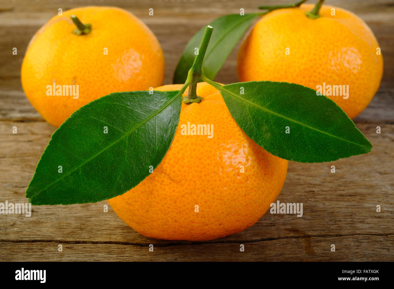 Ripe mandarin fruit on rustic wooden background Stock Photo - Alamy