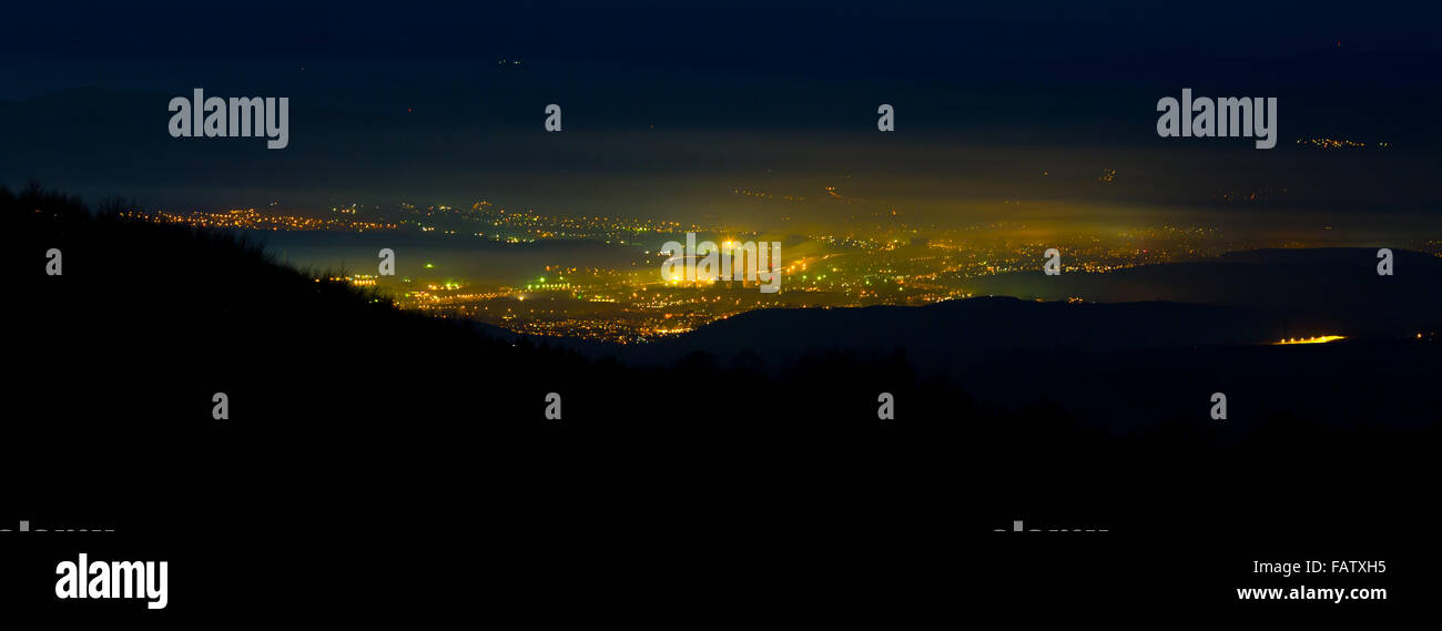 City by night covered with mist Stock Photo - Alamy