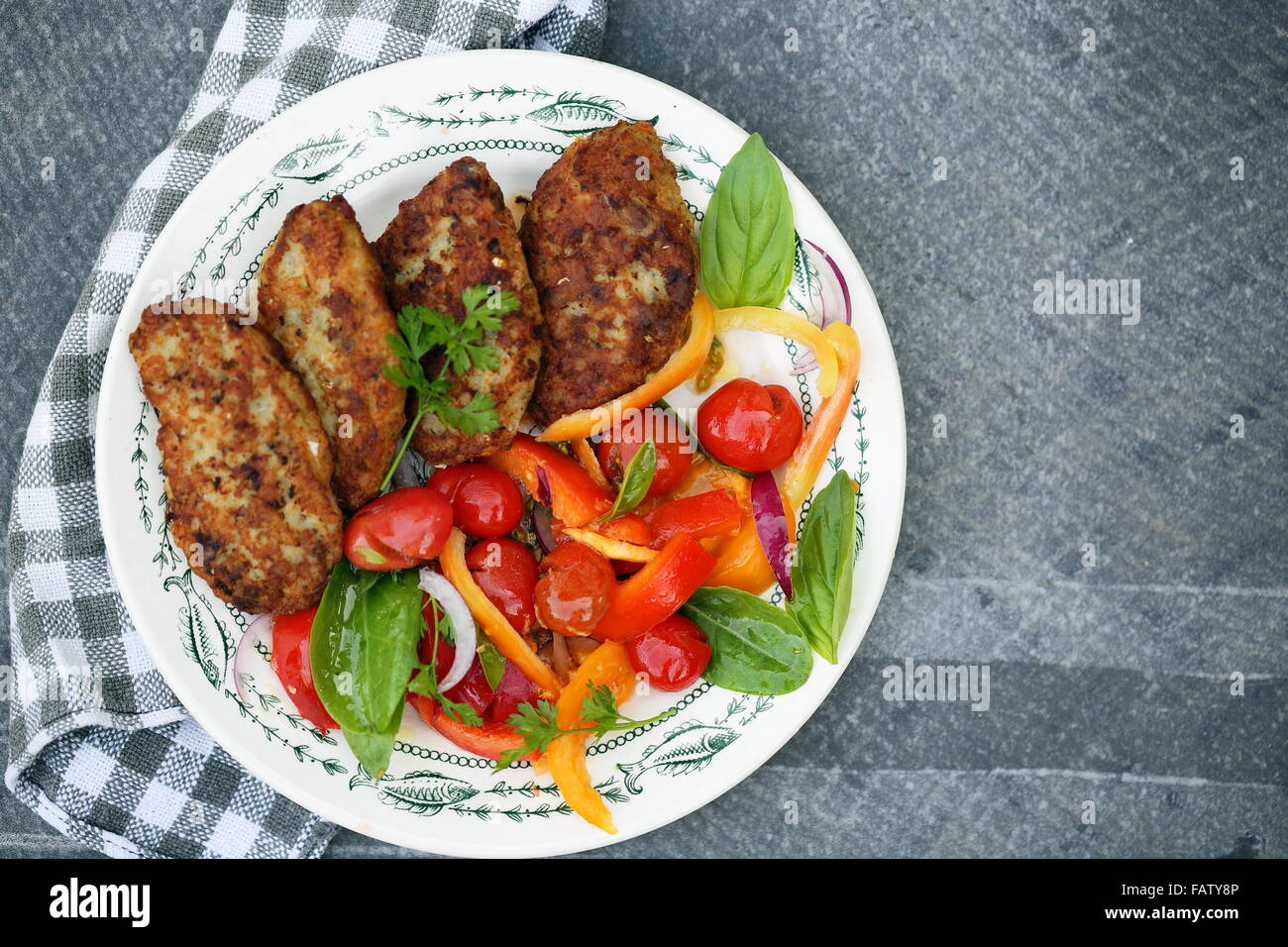 Fish cutlets with tomato, top view Stock Photo - Alamy