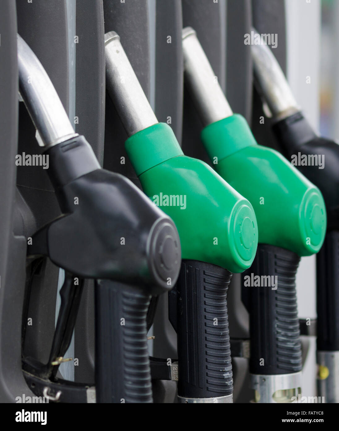 Color coded fuel nozzles at petrol station Stock Photo - Alamy