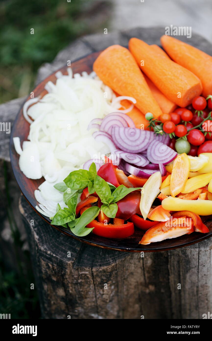 Sliced summer vegetables on a stump Stock Photo - Alamy