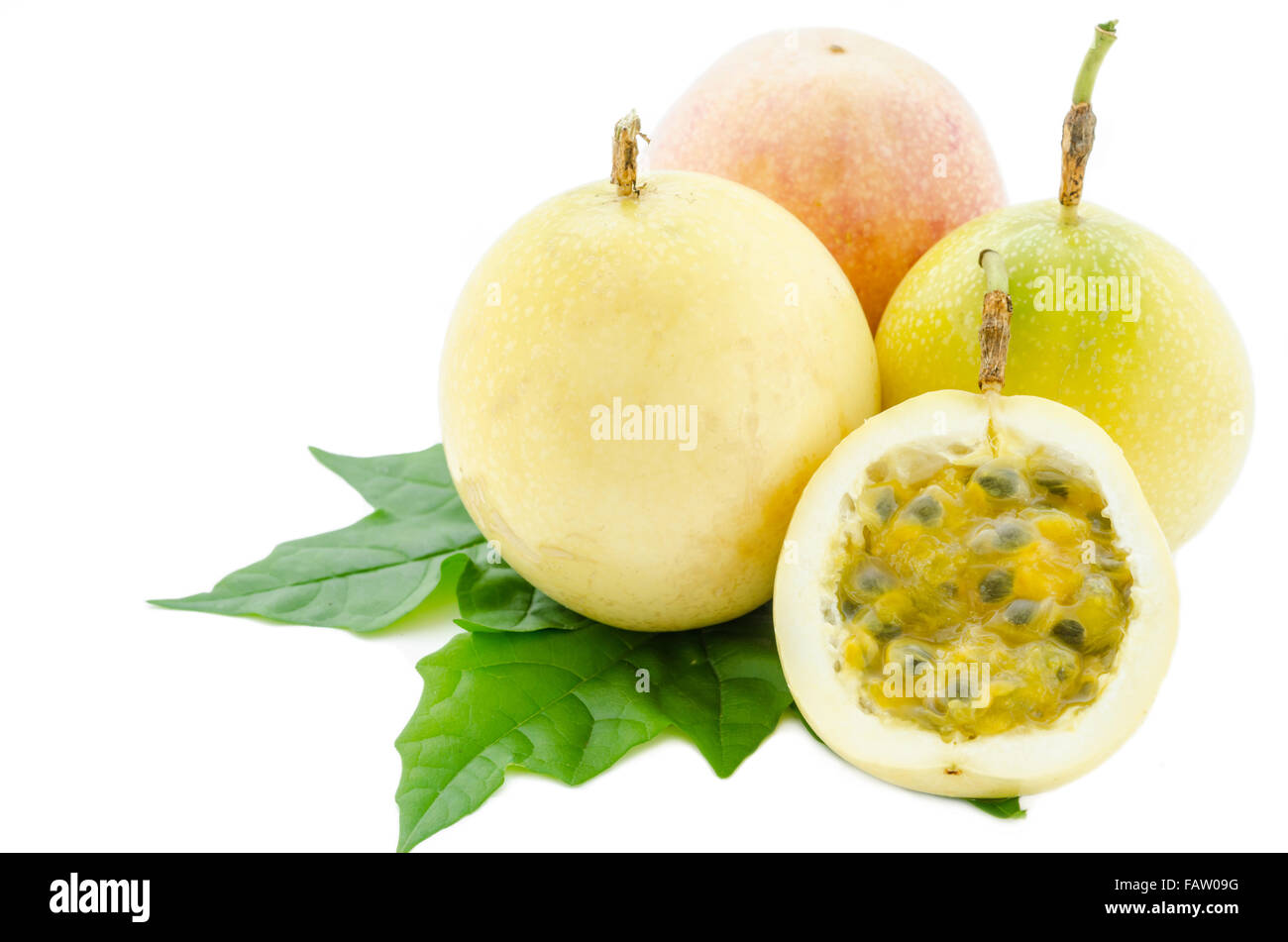 Yellow Passion fruit and green leaf on white background Stock Photo - Alamy