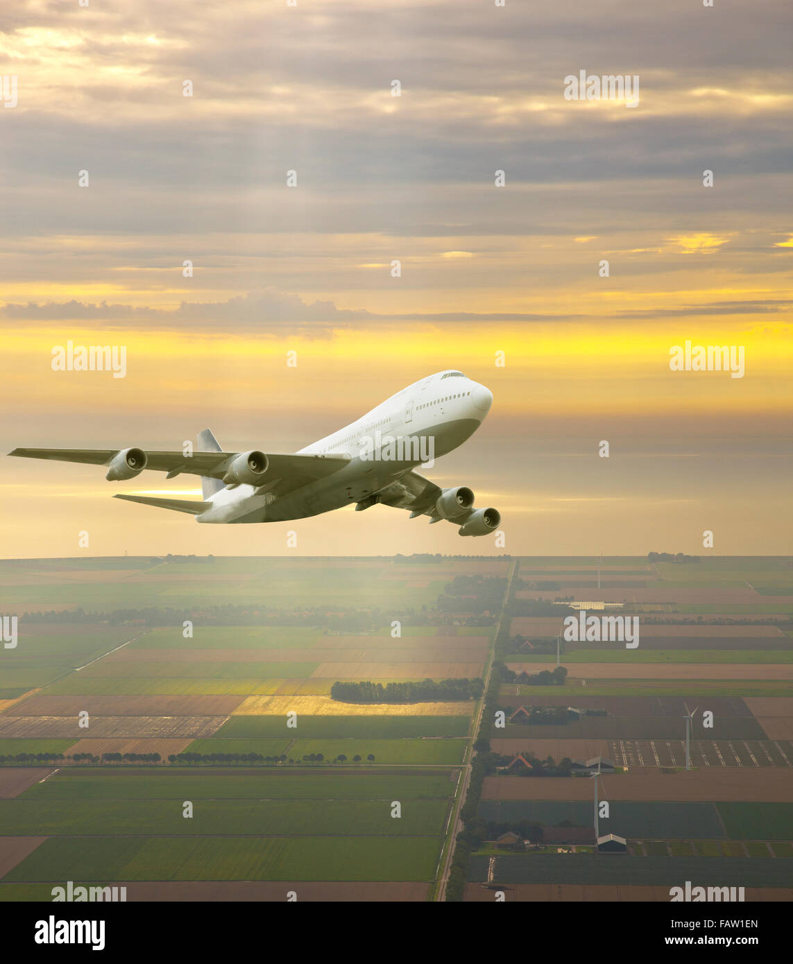 Airplane flying in beautiful yellow sky Stock Photo - Alamy