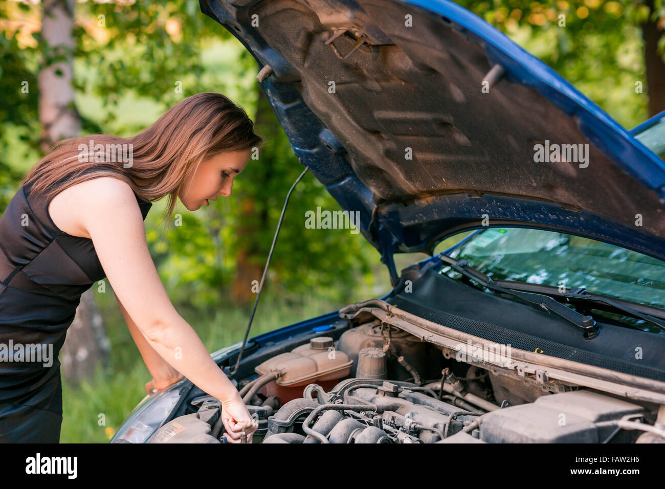 Beautiful business woman near her broken car, tring to repair Stock ...