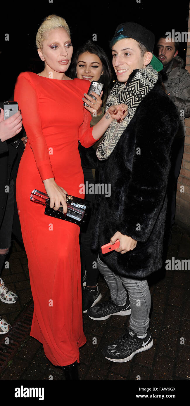 Lady Gaga poses for photos with fans as she leaves a recording studio ...