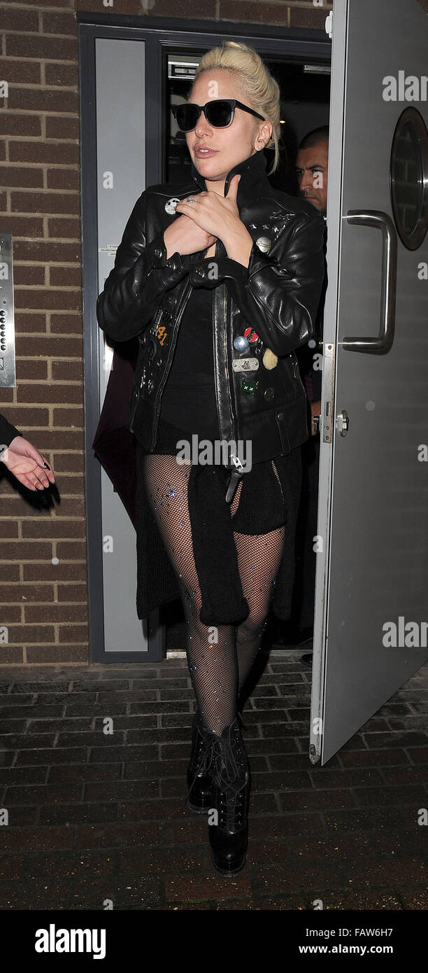 Lady Gaga poses for photos with fans as she leaves a recording studio ...