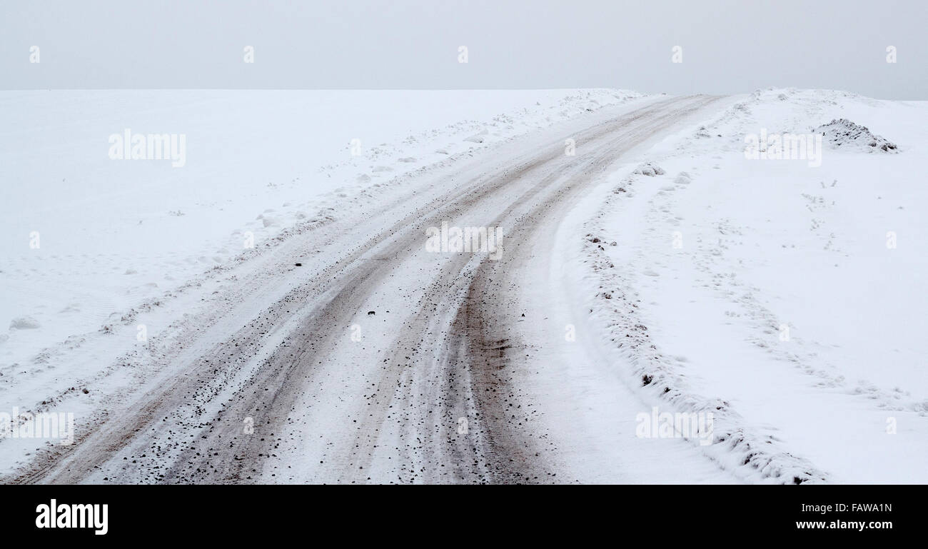overcast winter landscape with rural road ending on horizon Stock Photo ...