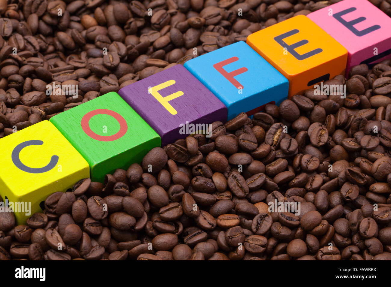 Colored children's cubes and coffee beans Stock Photo - Alamy