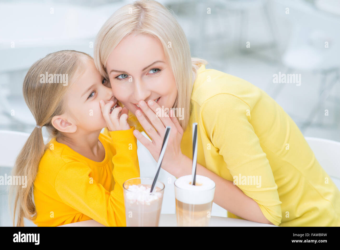 Happy mother and daughter sitting in the cafe Stock Photo - Alamy