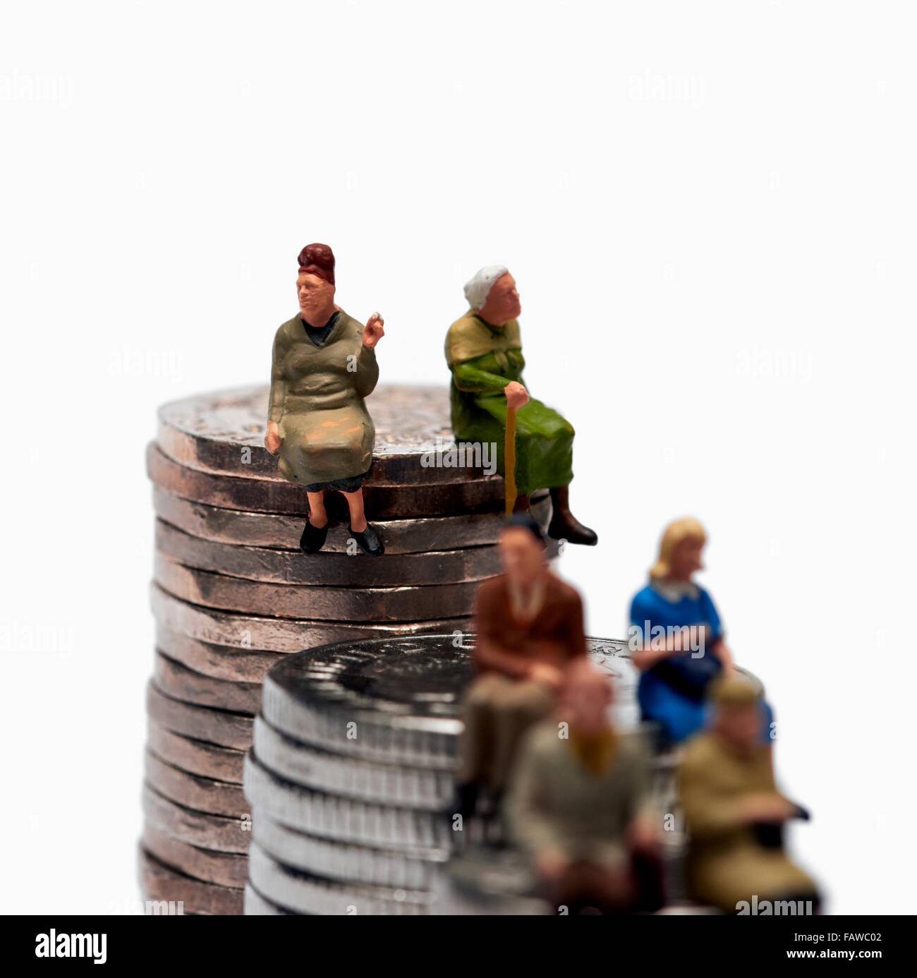 6 Miniature People sitting on stacks of british money coins Stock Photo ...