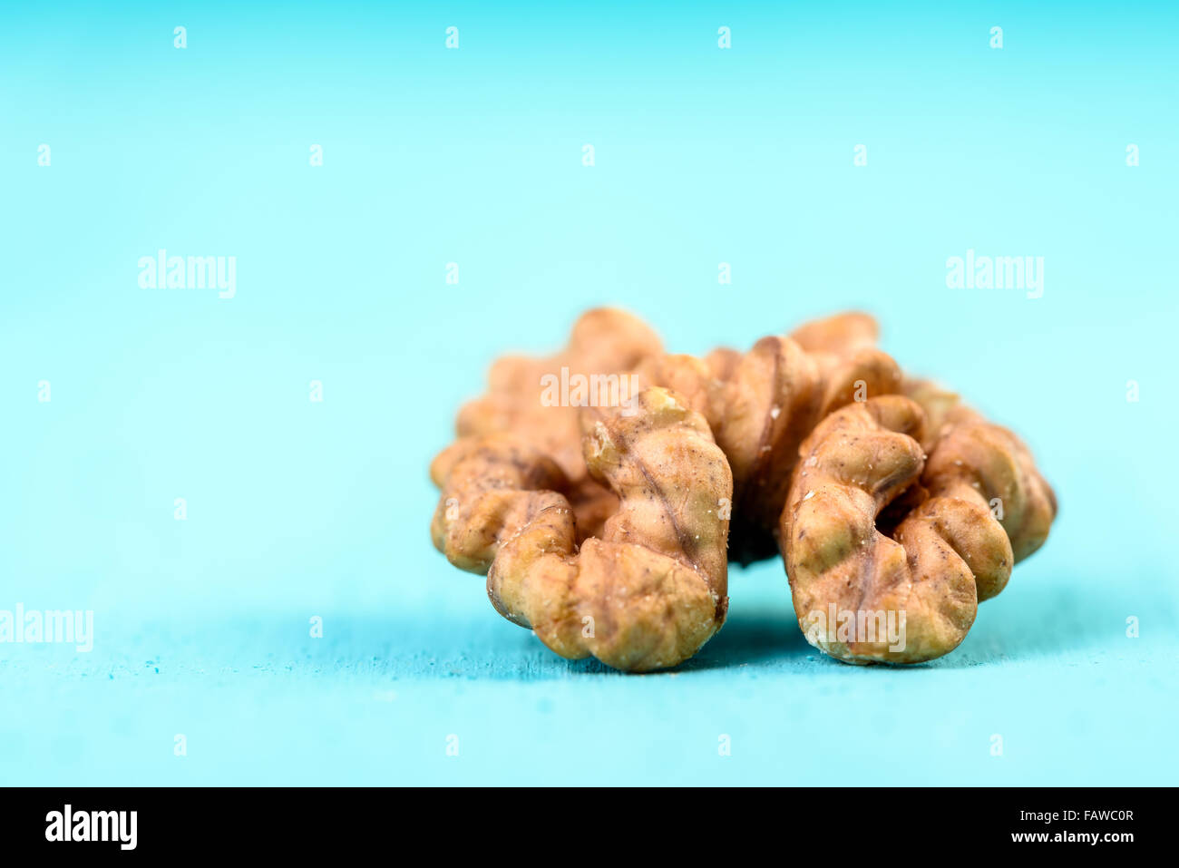 Half Walnut Kernel On Blue Background Stock Photo - Alamy