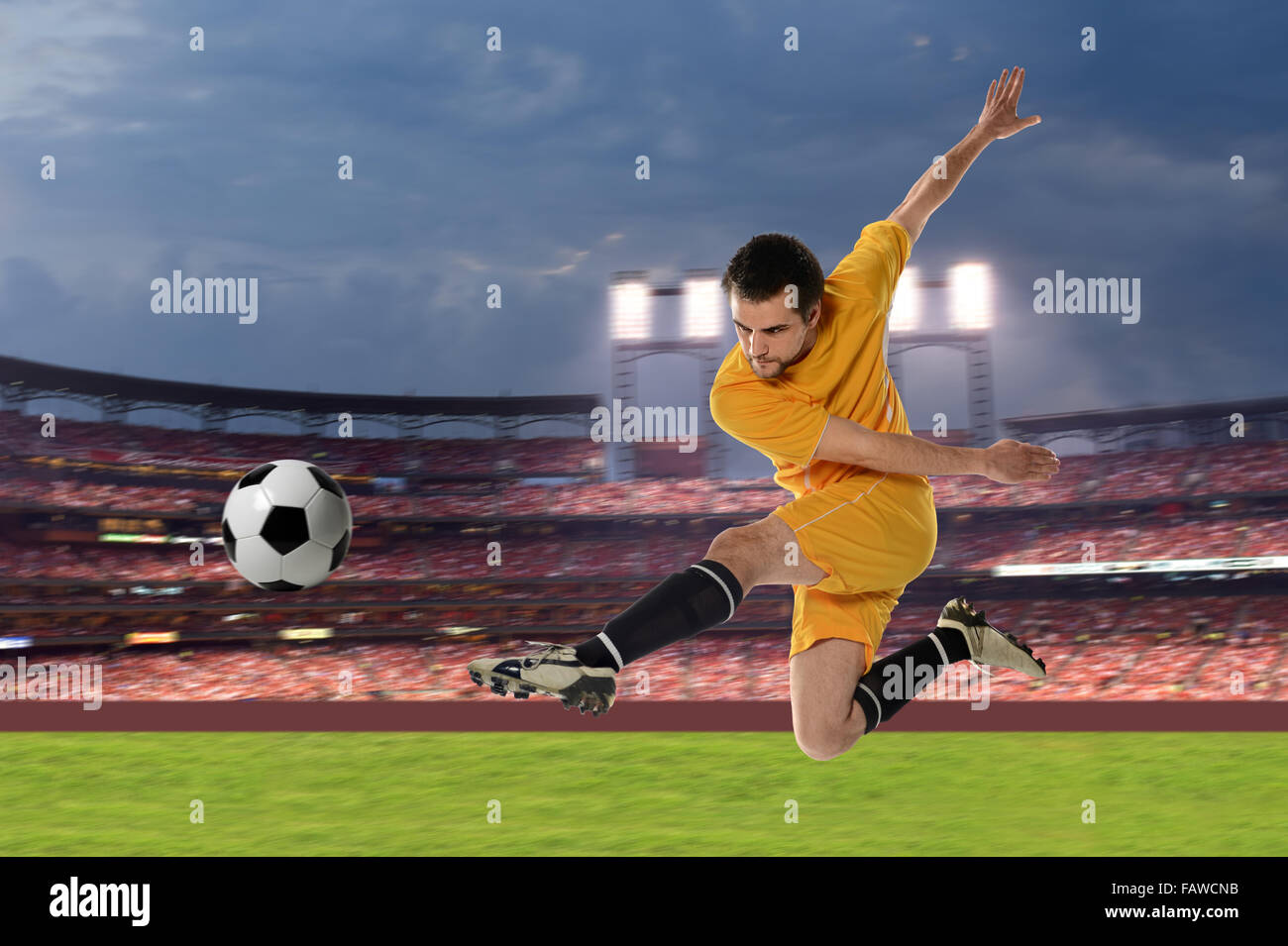 Young soccer player in action inside stadium Stock Photo - Alamy