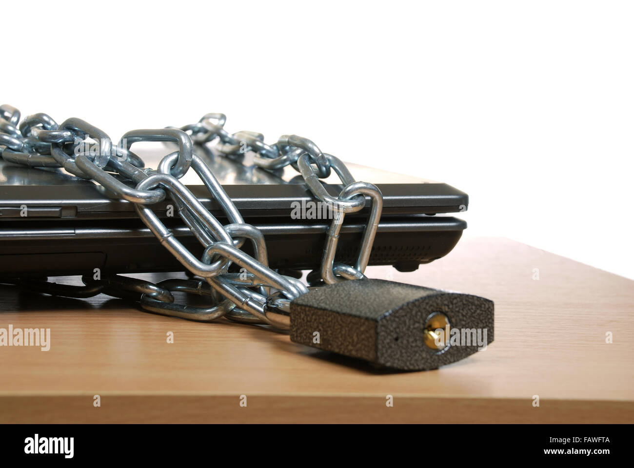 laptop, bound in a chain with a closed lock on white background. Data ...