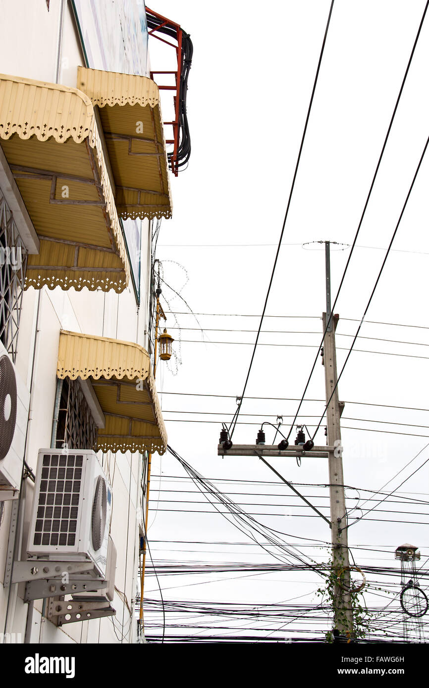 Side of the building and electrical line clutter Stock Photo - Alamy