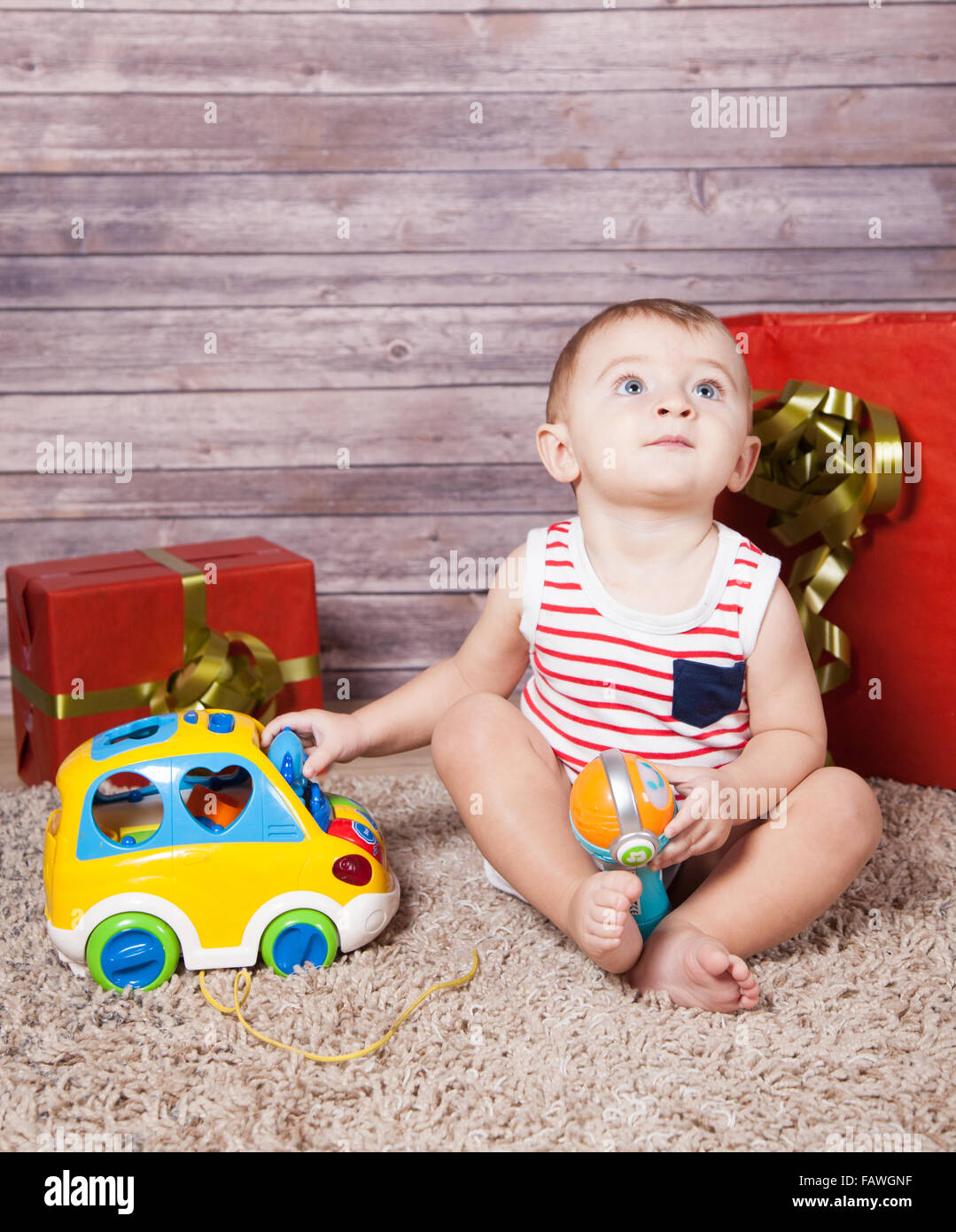 Portrait of 1 year old baby boy, with presents, studio shot Stock Photo ...