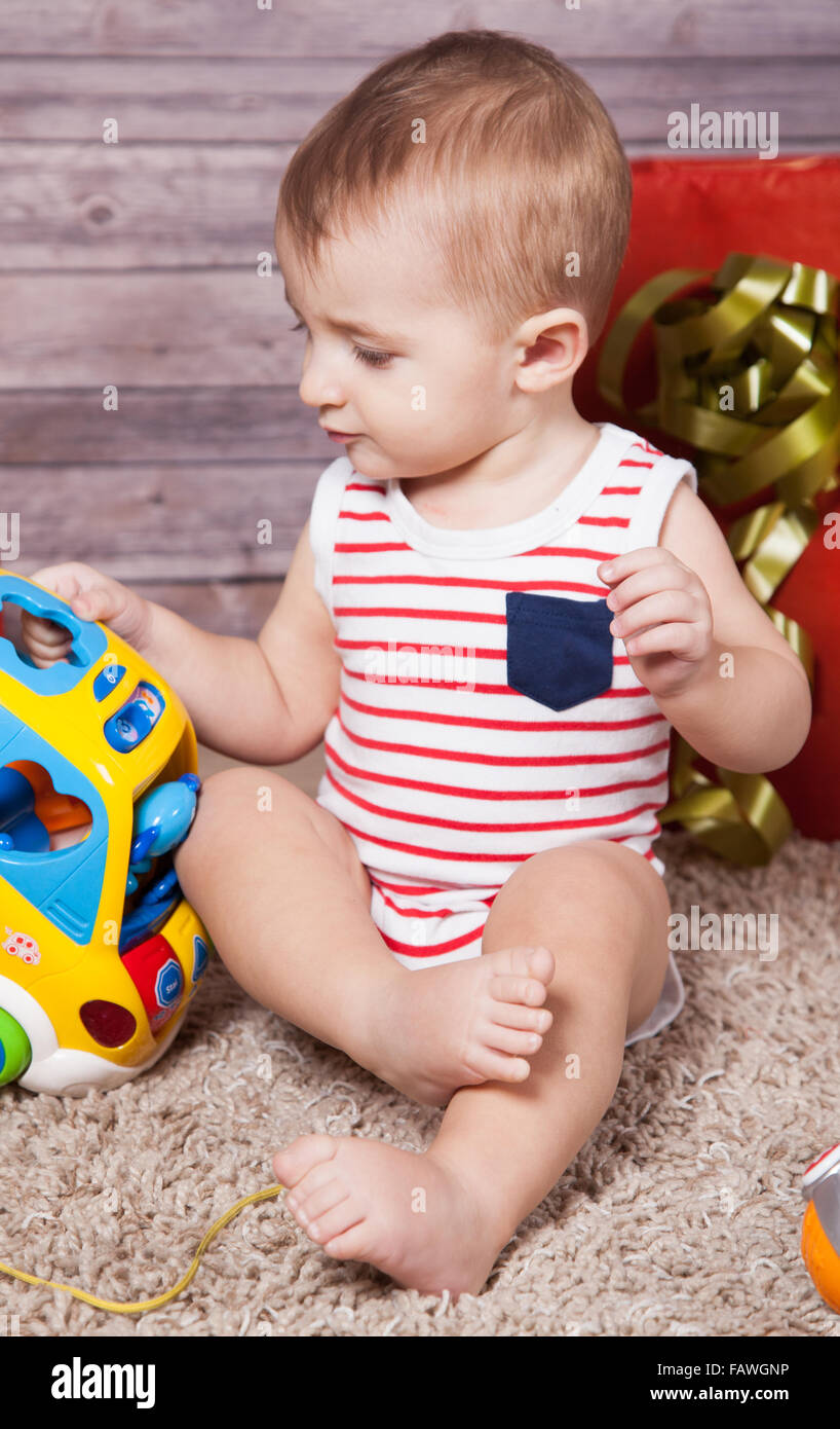 Portrait of 1 year old baby boy, with presents, studio shot Stock Photo ...