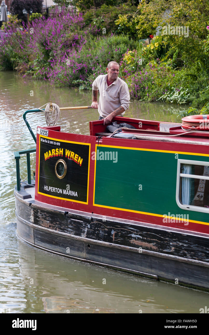 Man steering narrow boat narrowboat on the Kennet and Avon Canal ...