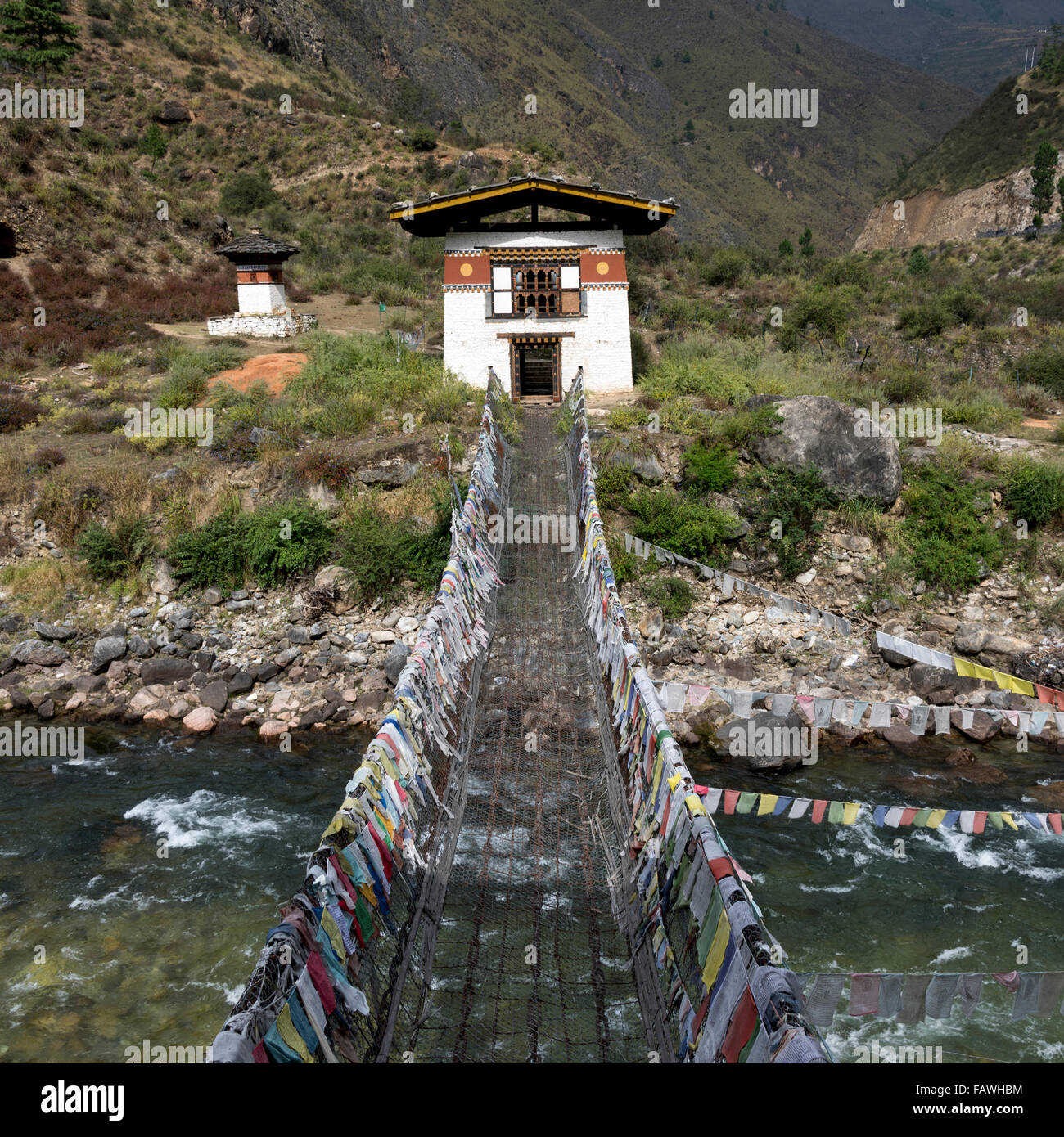 Suspension bridge made from wood and chain across Paro river, near ...