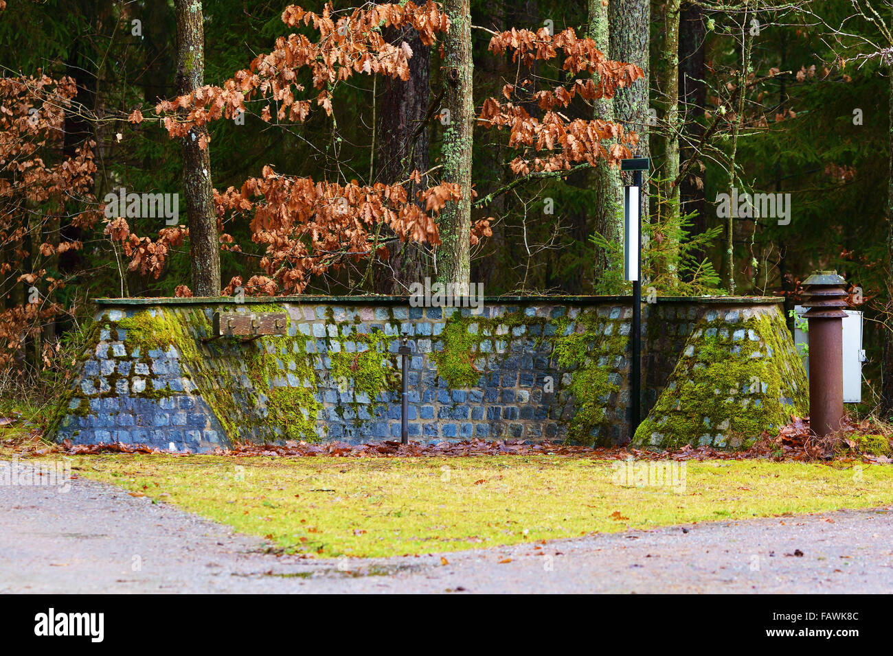 An empty water and vase service depot at a cemetery. Moss is covering ...