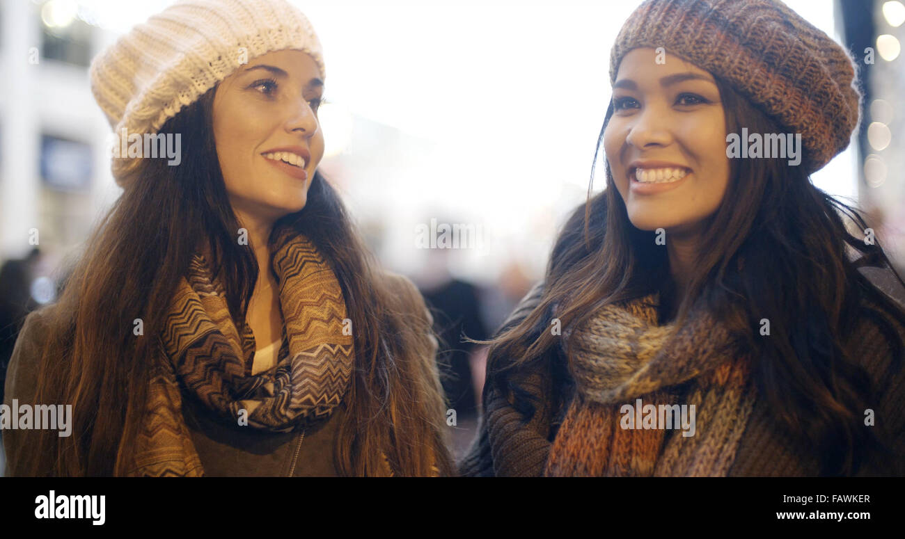 Two young woman enjoying a winter night out Stock Photo - Alamy