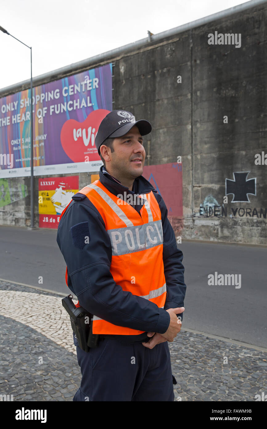 Police officer in a high vis jacket at the port gates of Madeira's ...