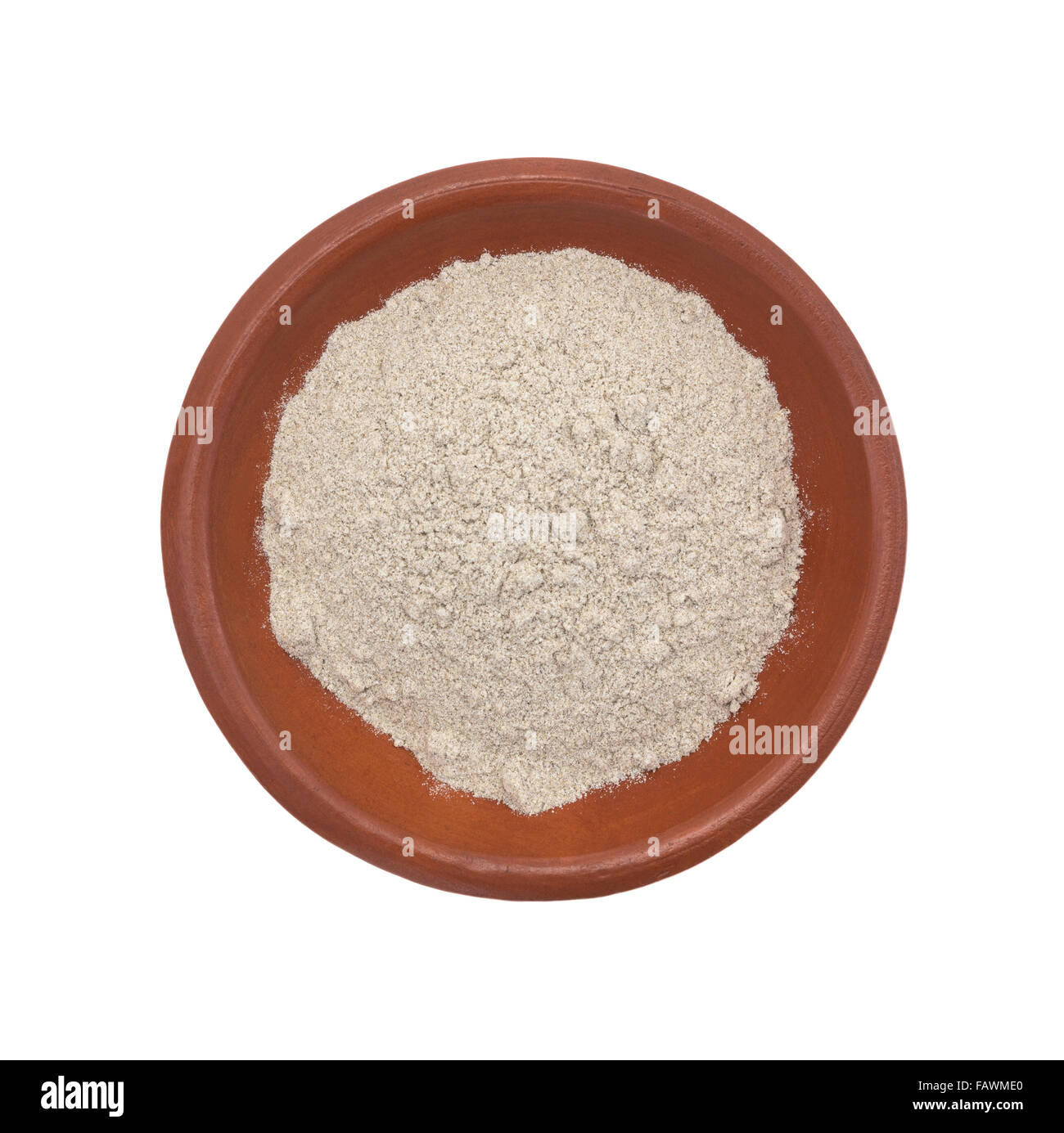 Top view of a small bowl with a portion of dry brown gravy mix isolated ...