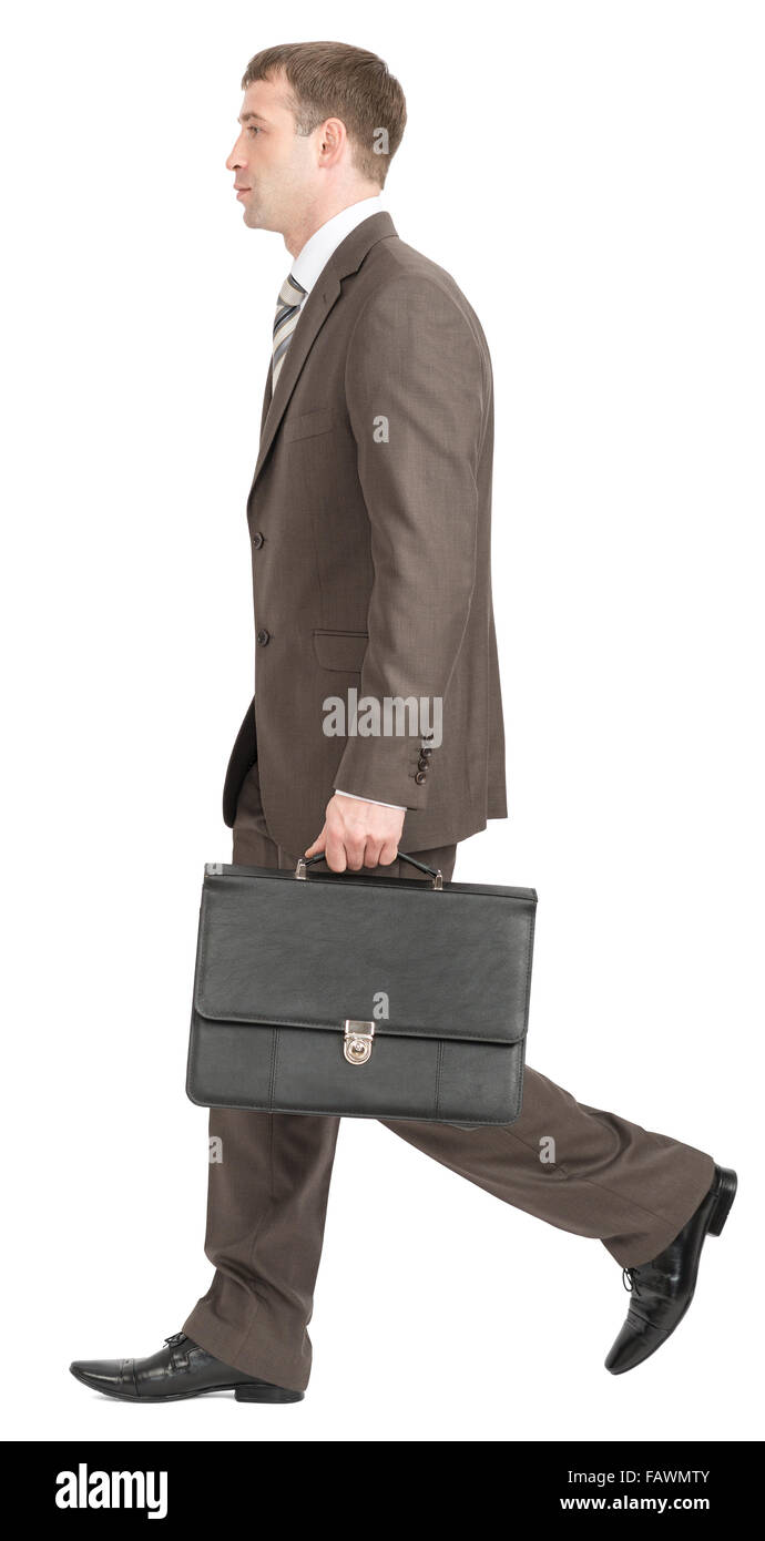 Businessman walking with suitcase Stock Photo - Alamy