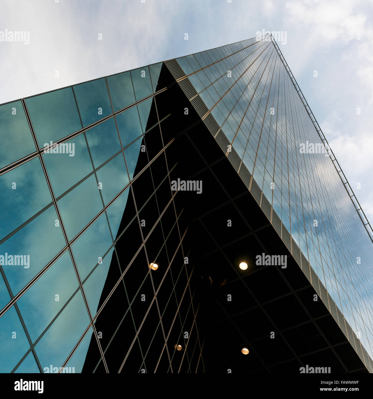 Skyscraper with glass walls reflecting the sky; Dallas, Texas, United ...