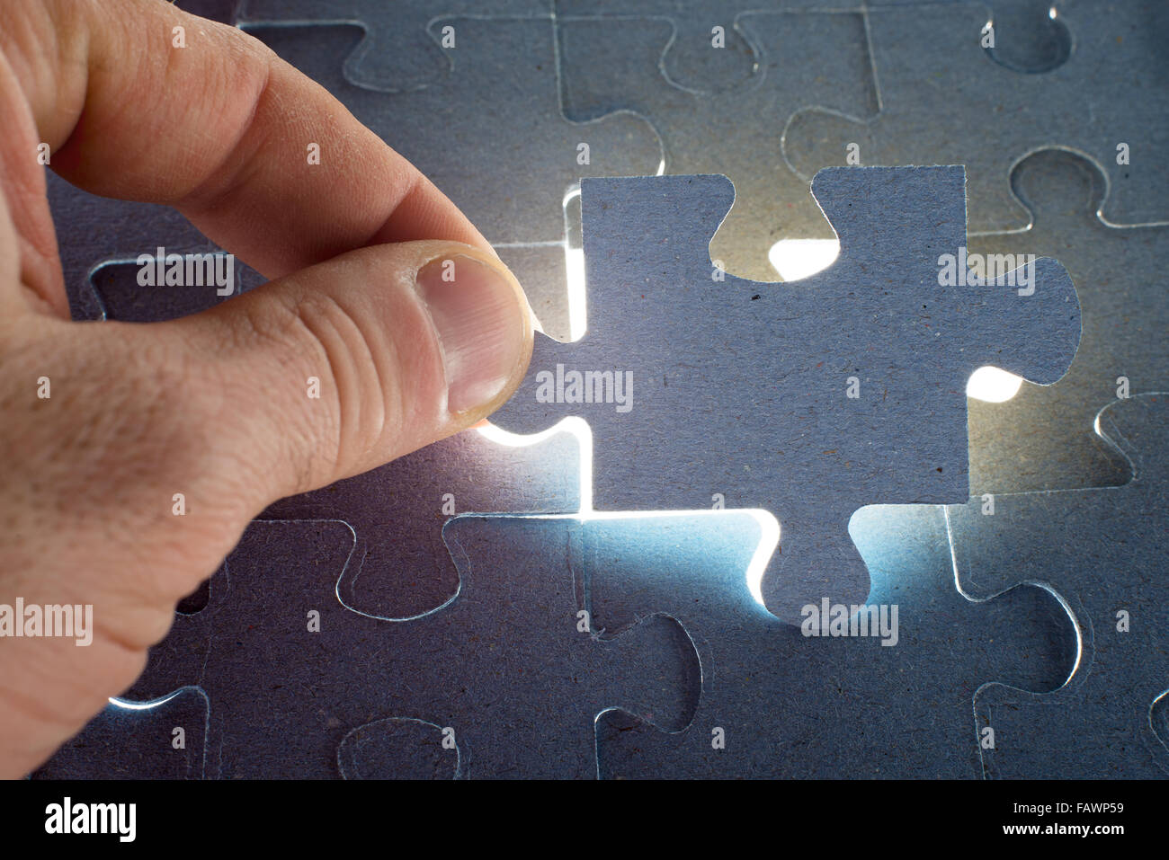 Missing jigsaw puzzle piece with light glow Stock Photo - Alamy