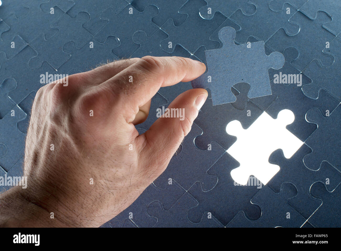 Missing jigsaw puzzle piece with light glow Stock Photo - Alamy