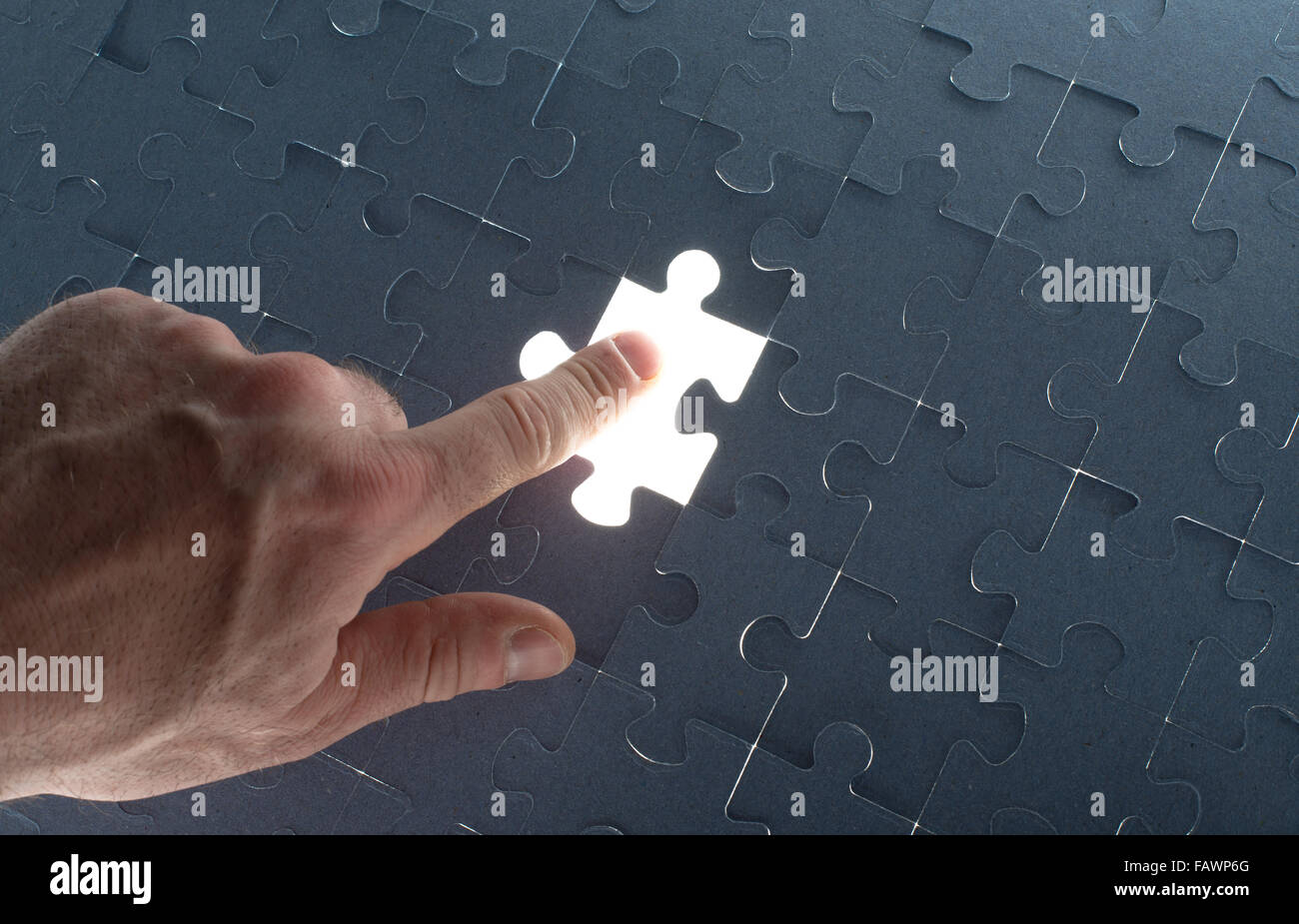 Missing jigsaw puzzle piece with light glow Stock Photo - Alamy