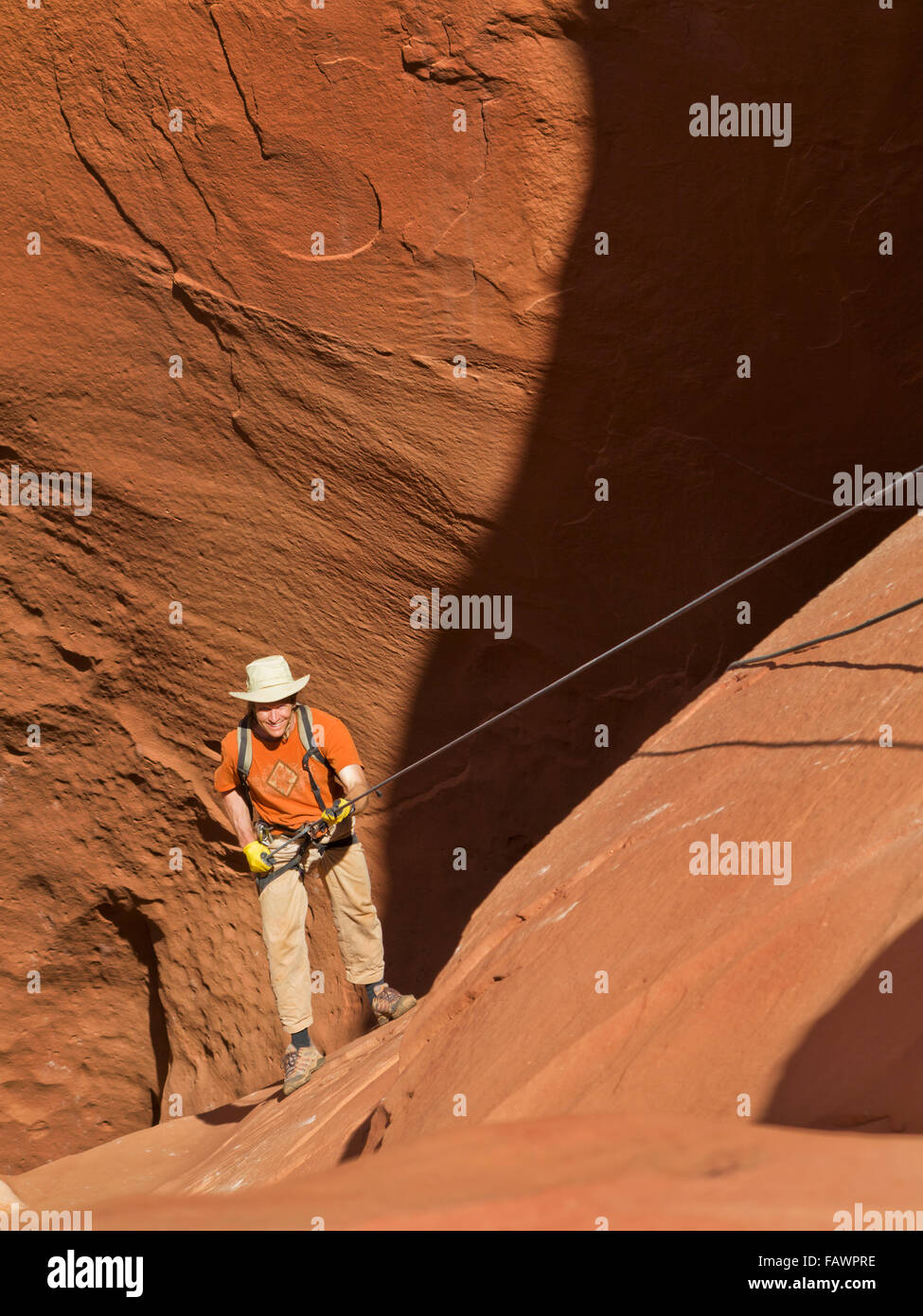 Adventurer exploring a desert slot canyon, San Rafael Swell; Utah ...
