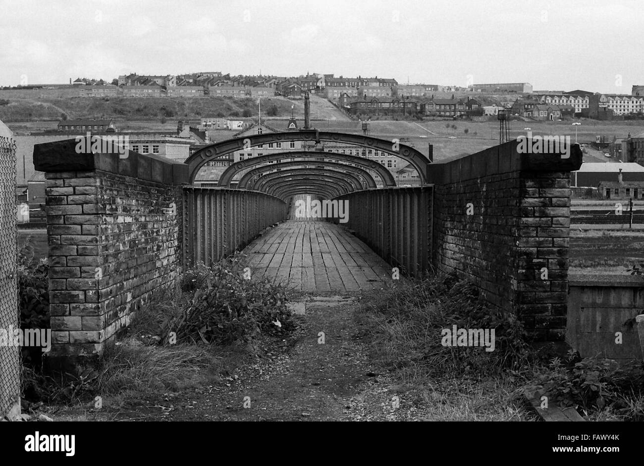 Bradford, West Yorkshire. Old footbridge across rail tracks between ...