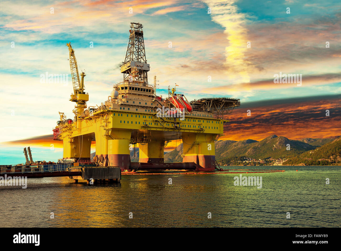 Oil drilling rig in sunset time Stock Photo - Alamy